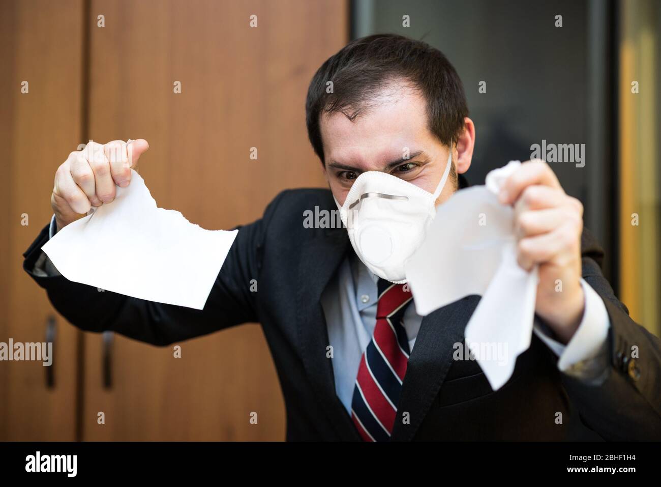 Angry masked business man destroying a document, bad business people ...