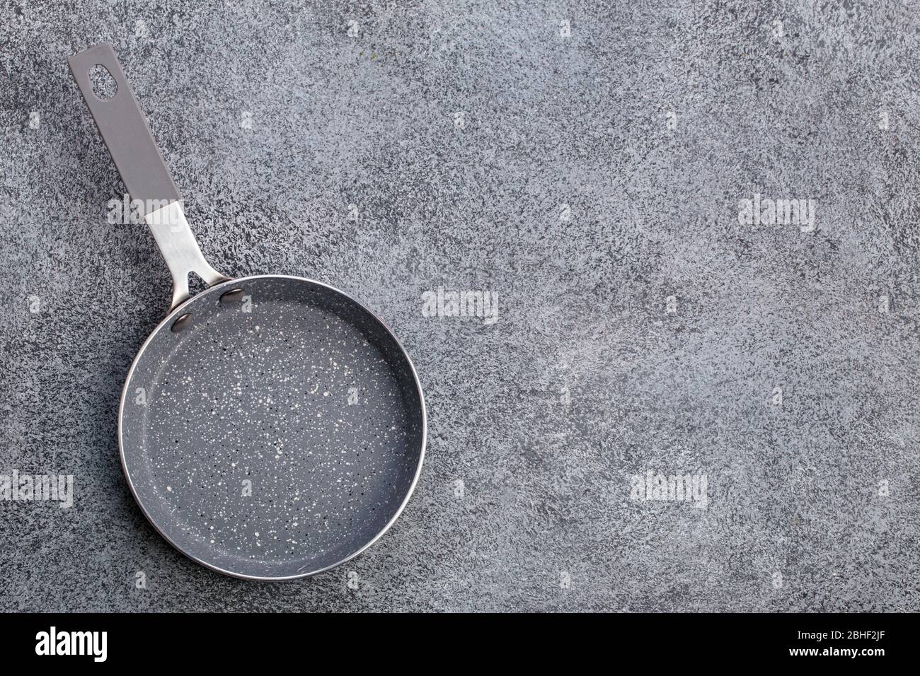 Small gray pan on gray Stock Photo - Alamy