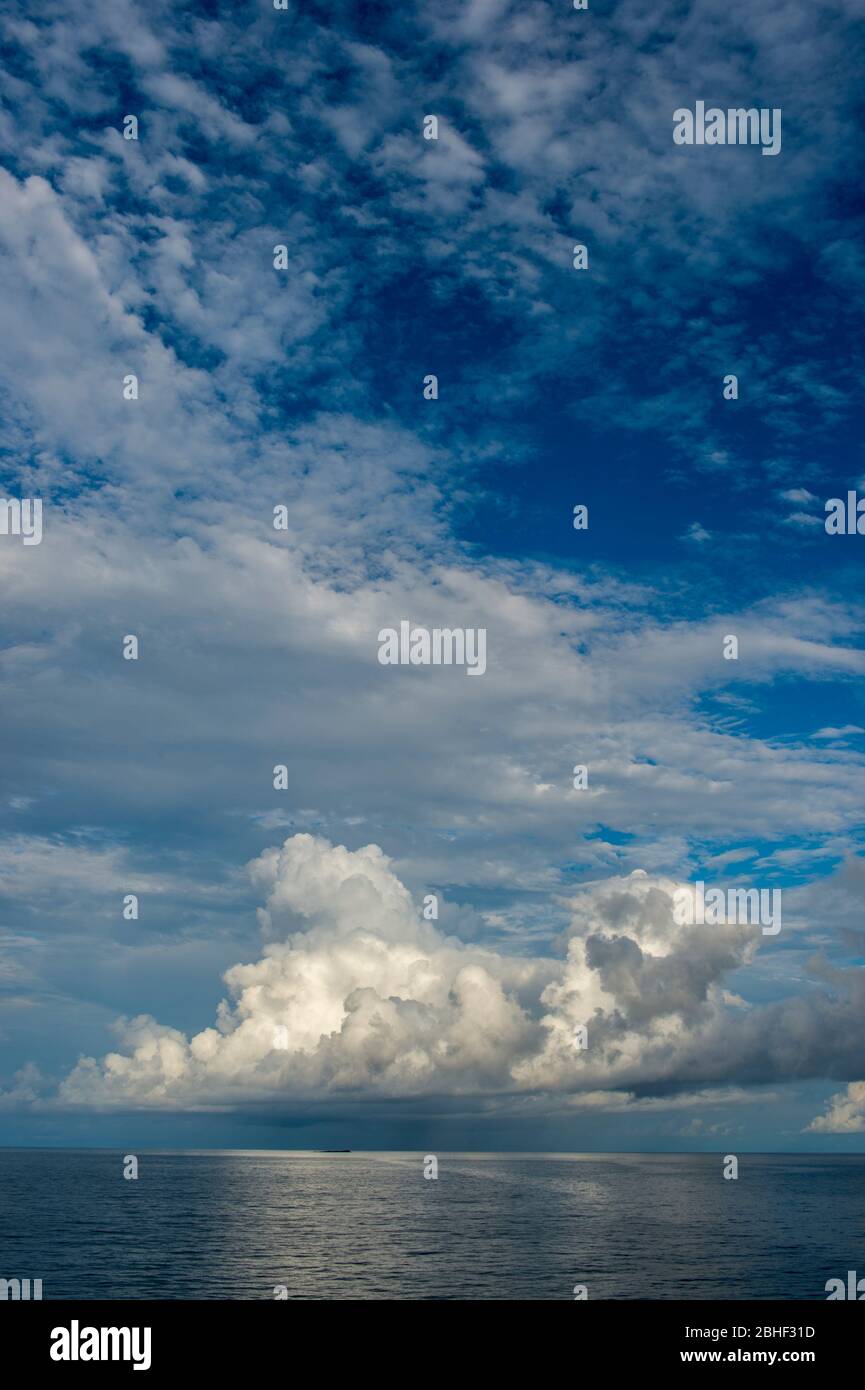 Cumulus cloud buildup over the Atlantic Ocean near Principe Island, Sao ...