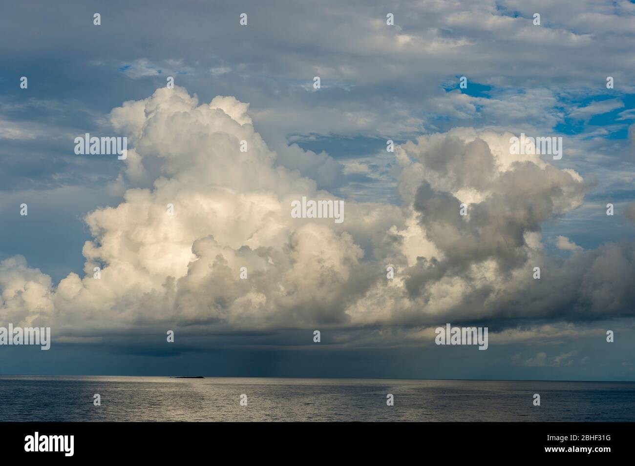 Cumulus cloud buildup over the Atlantic Ocean near Principe Island, Sao ...