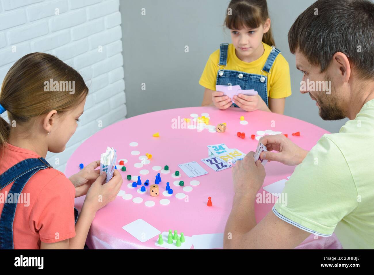 Family plays board card games hi-res stock photography and images - Alamy