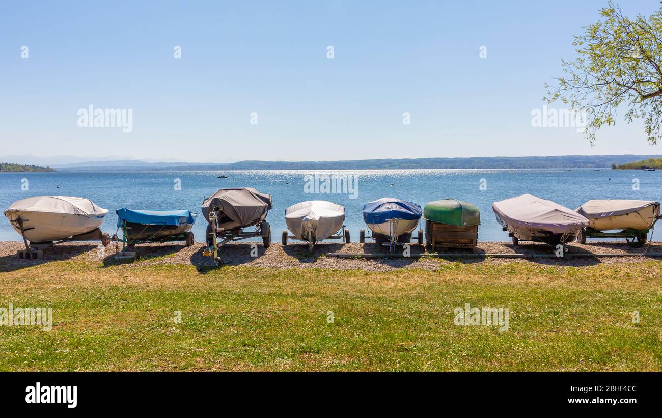 Sailboats on land at the shores of Lake Ammer (Ammersee). Lined up in a ...
