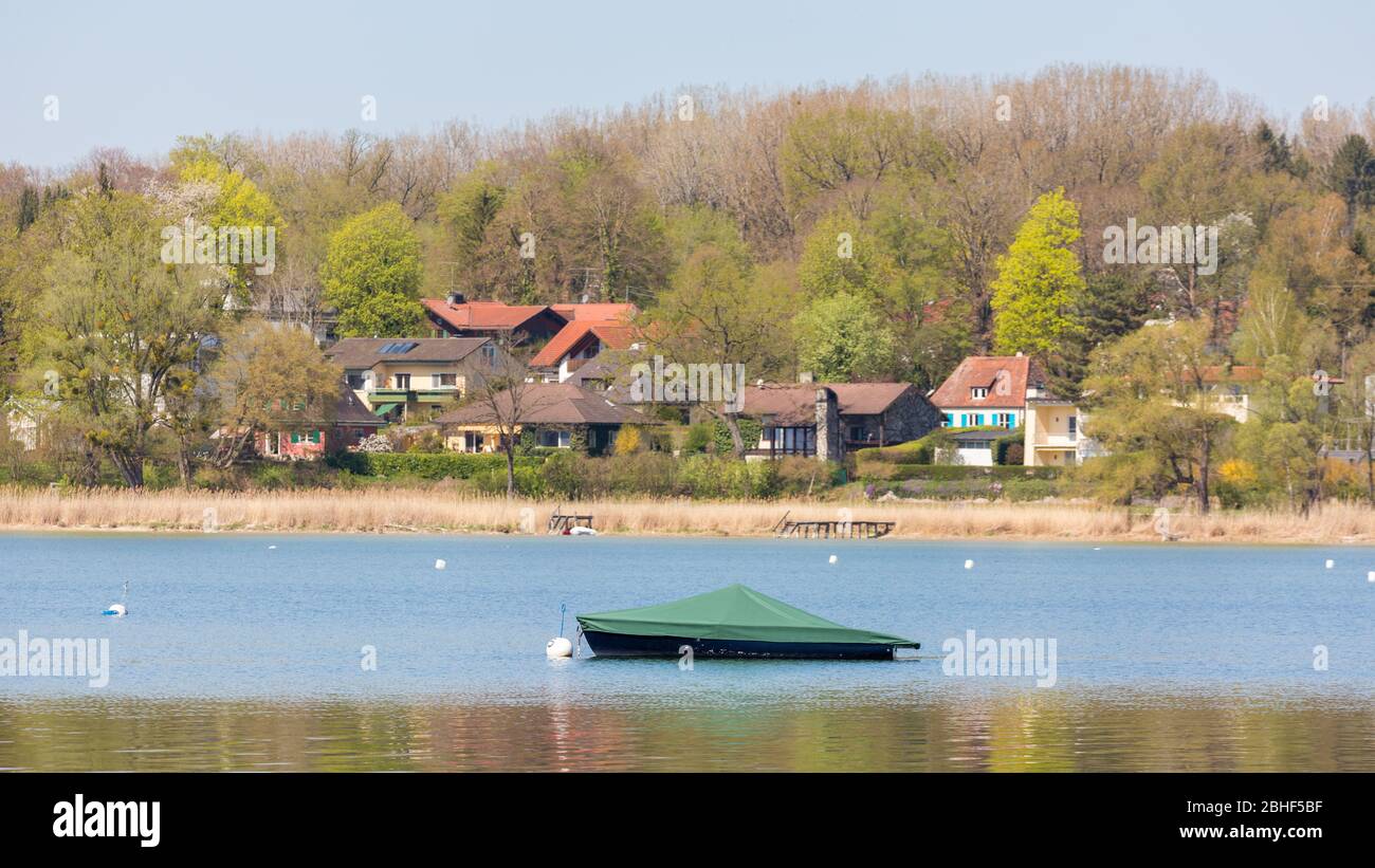 Boat covered with green tarpaulin anchoring at Lake Ammer (Ammersee ...