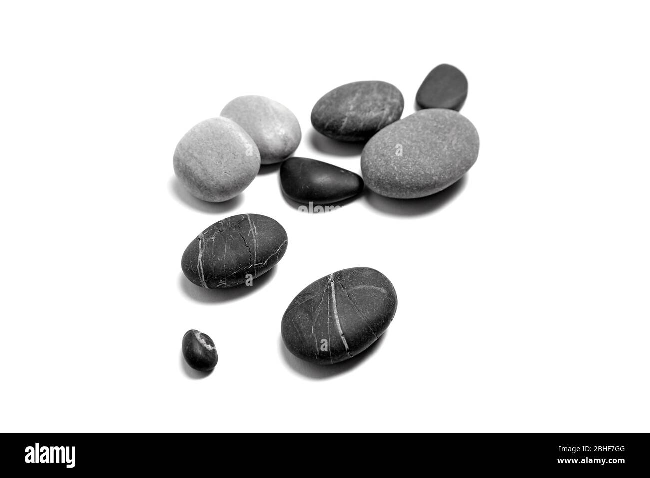 Scattered sea pebbles. Heap of smooth gray and black stones isolated on ...