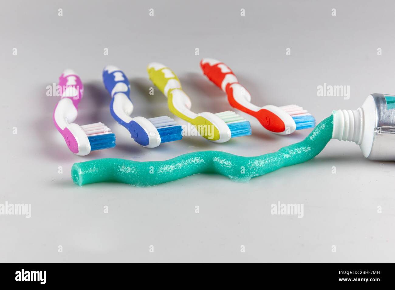 Toothbrushes and green toothpaste on white background Stock Photo - Alamy