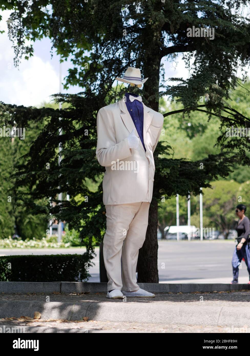 Street performer dressed as invisible man standing and giving a thumbs ...