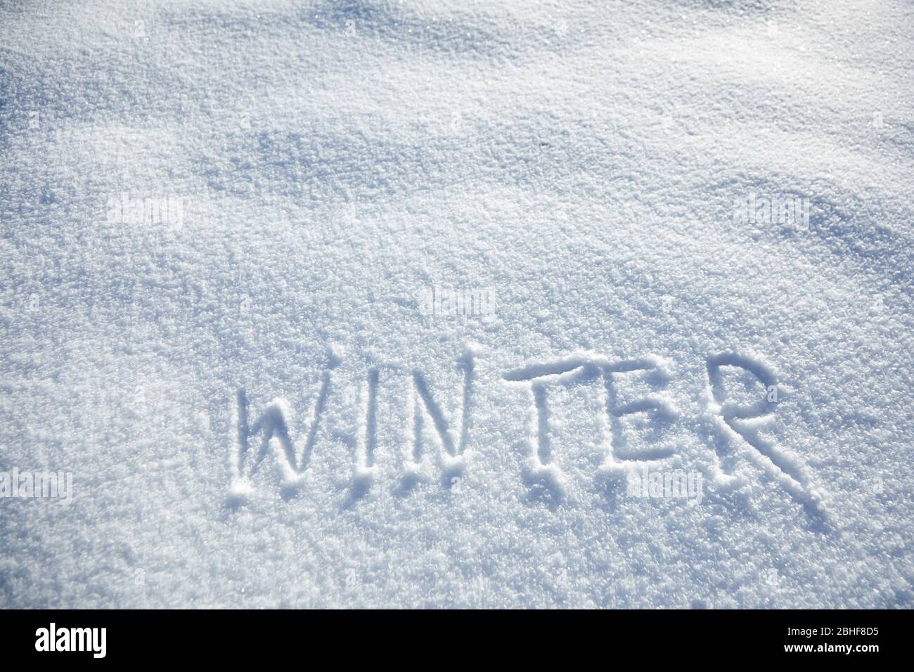 Winter background, inscription winter on snowy surface, natural snow ...