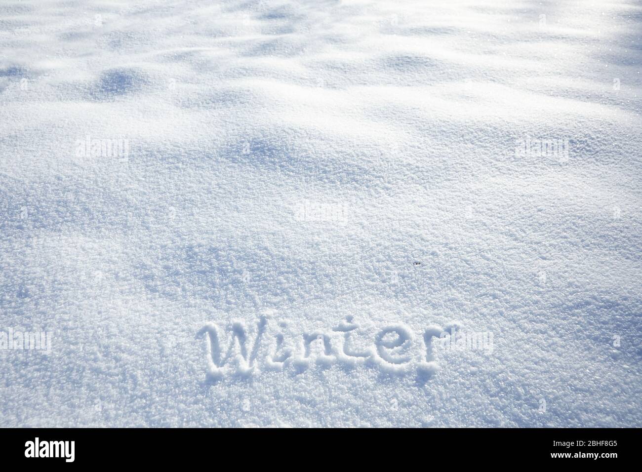 Winter background, inscription winter on snowy surface, natural snow ...