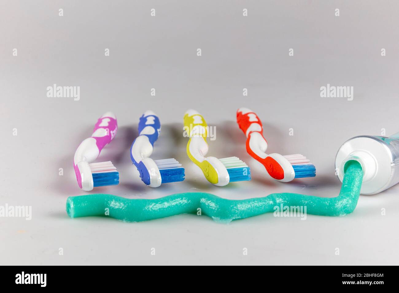 Toothbrushes and green toothpaste on white background Stock Photo - Alamy
