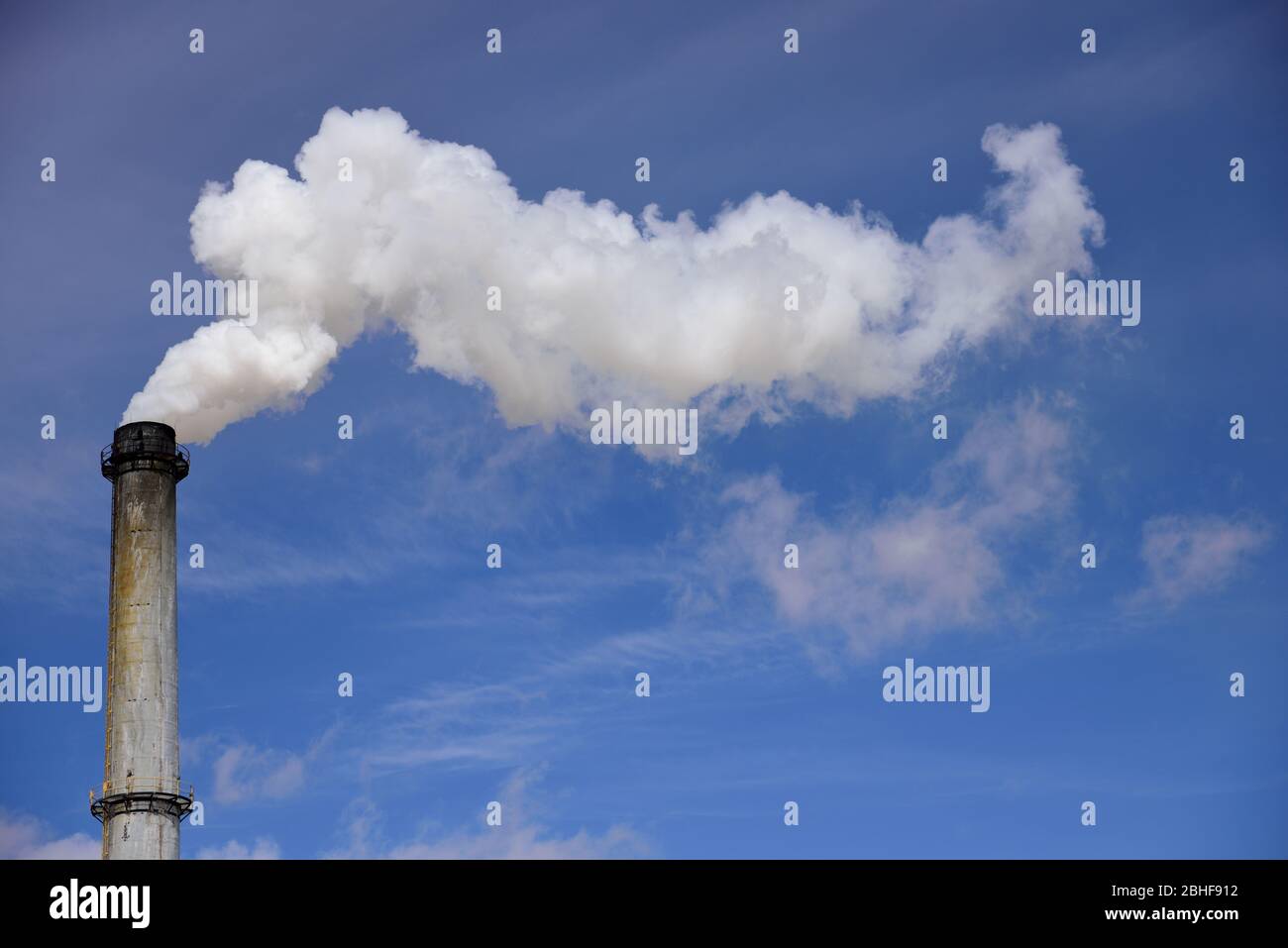 Sugar Mill, Single smoke stack and emissions, blue sky and clouds, in ...