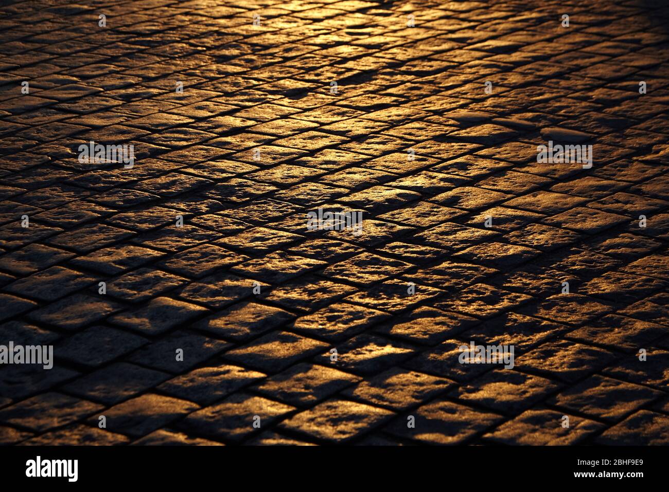 Stone road in the street of old town. Top layer of a roadway in a ...
