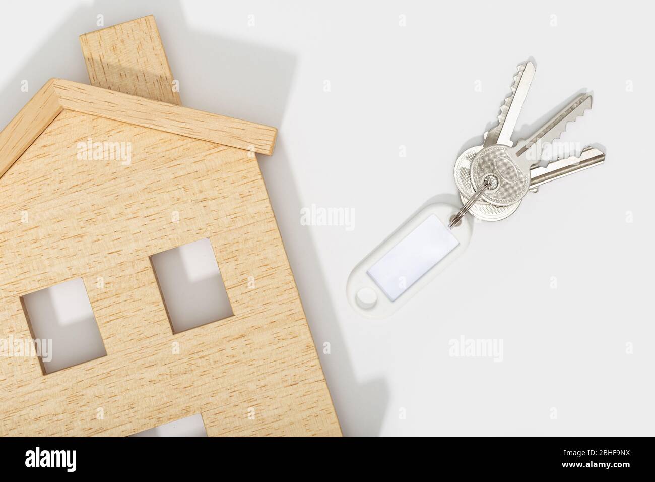 Real estate concept. House icon with keys on white background. Mock up ...