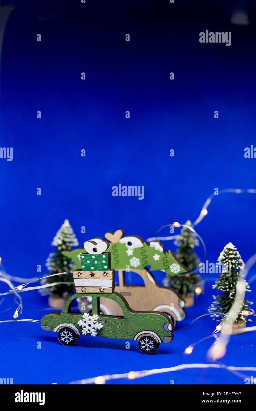 Christmas toy cars with christmas tree on blue background, with garland ...