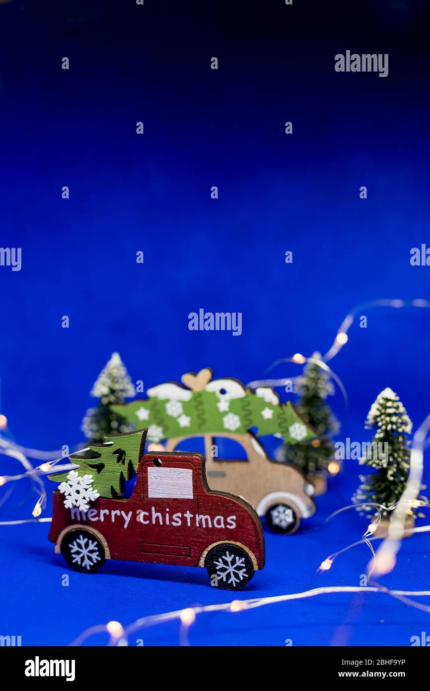 Christmas toy cars with christmas tree on blue background, with garland ...