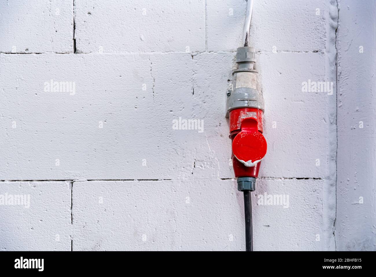 electrical three-phase connection to the white wall from the building ...