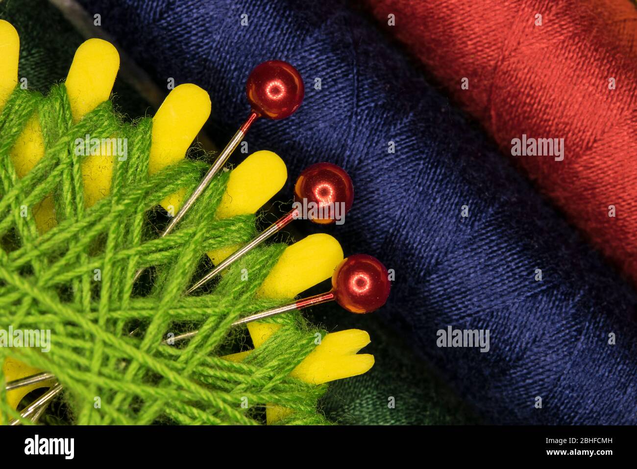 stiching pins and colorful thread Stock Photo - Alamy