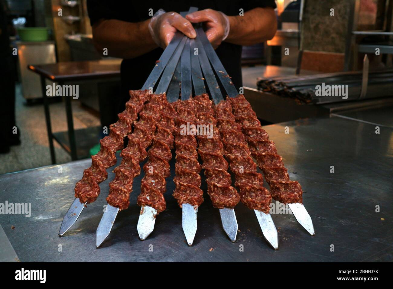Meat kebabs on steel skewers in a row Stock Photo - Alamy