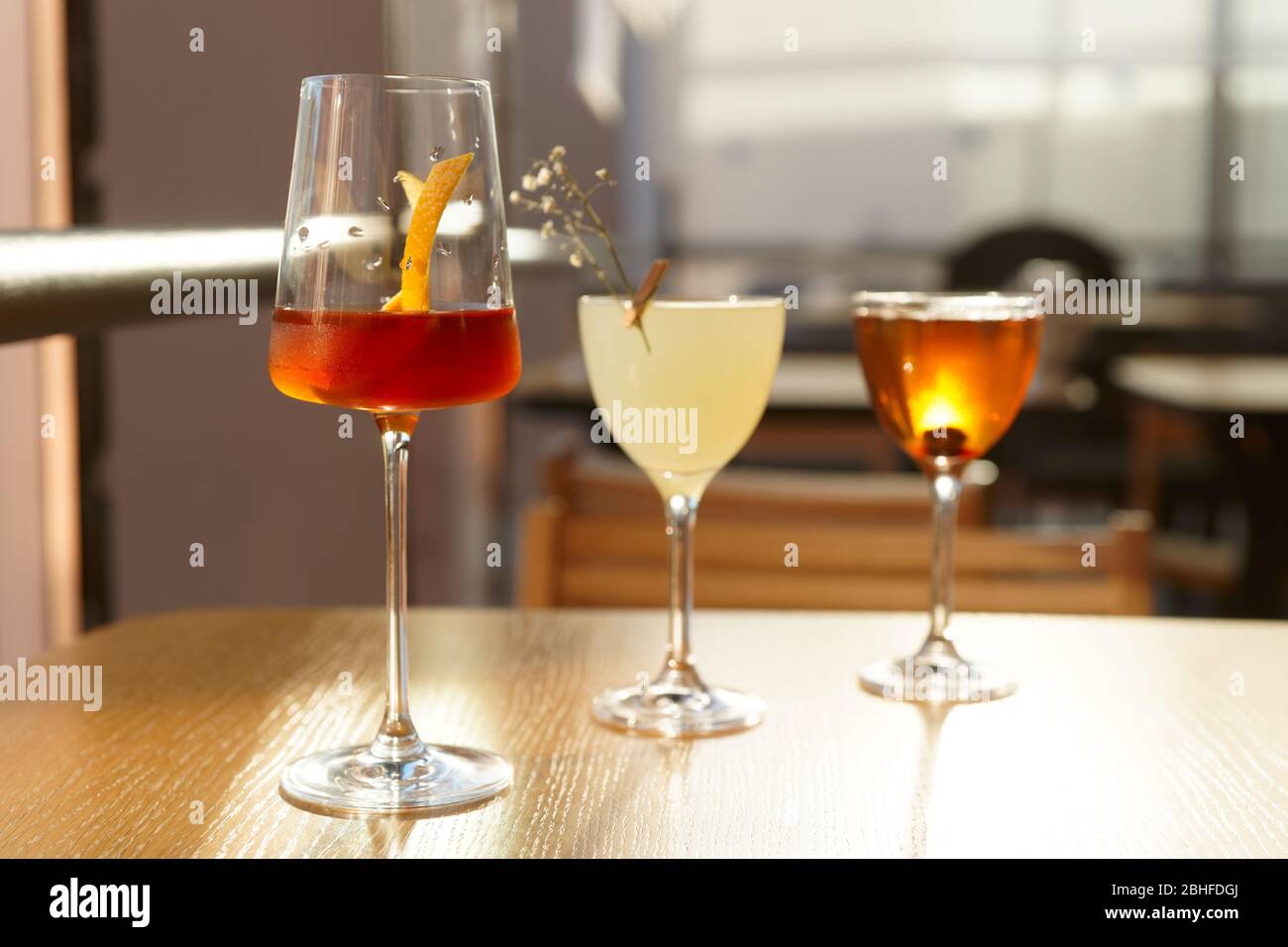 Three simple looking cocktails on restaurant table, sunlight Stock ...