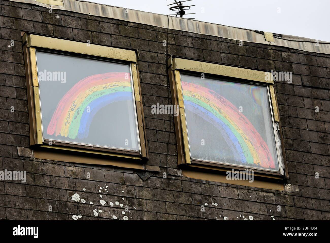 London, UK 25 Apr 2020 - A hand colourful rainbow is displayed in a ...