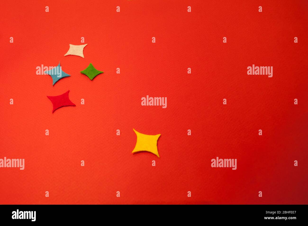 There are 5 rectangular colored stars on red cardboard. For background ...