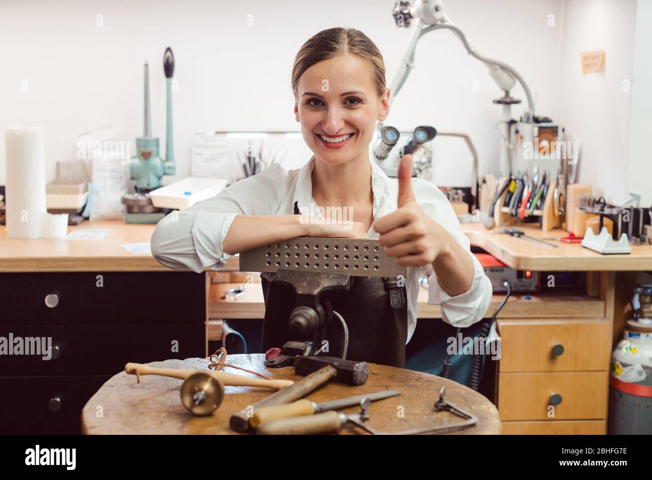 Portrait of a goldsmith in her workshop standing amidst tools Stock ...