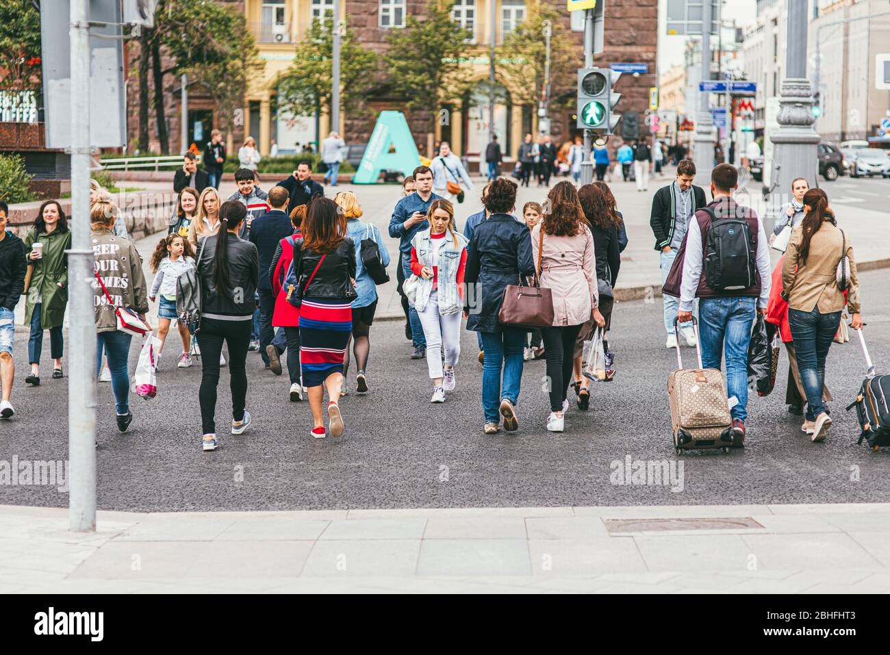 MOSCOW, RUSSIA - JULY 7, 2015: A crowded crowd of people crosses the ...