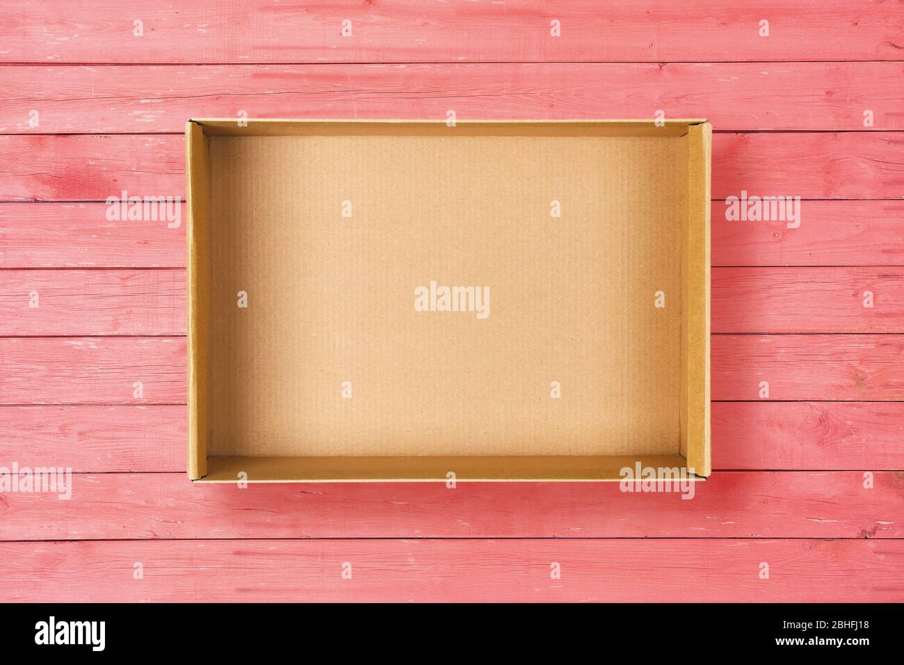 Open cardboard box on pink background. Empty cardboard package on pink ...
