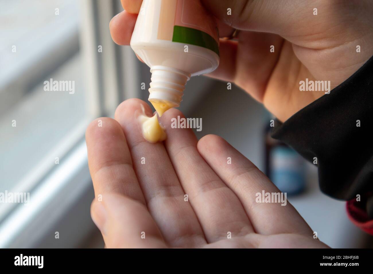 The cream is squeezed out of the tube. Cream on the hand Stock Photo ...