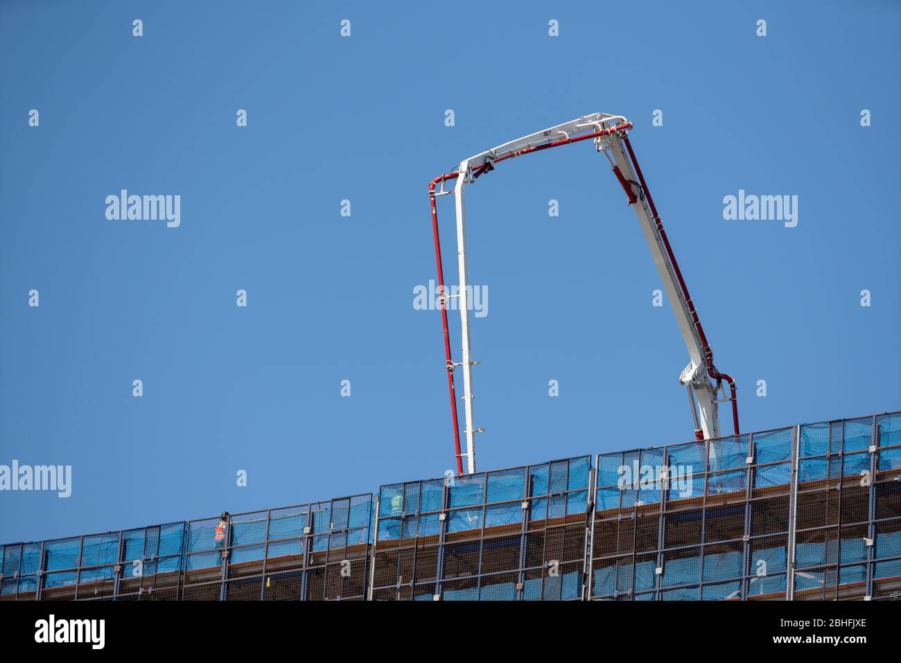 Cement pouring crane top of highrise building Stock Photo - Alamy