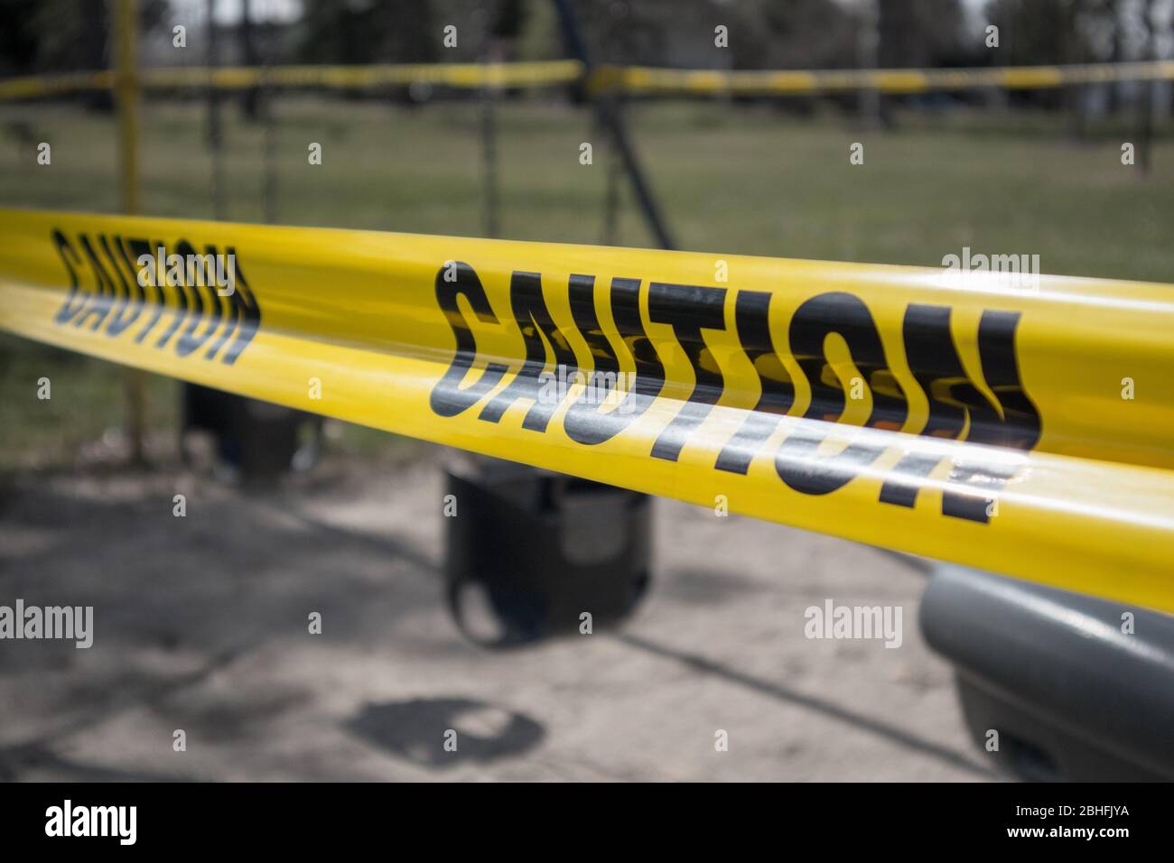 Caution tape to prevent access to children's play ground. Close up ...