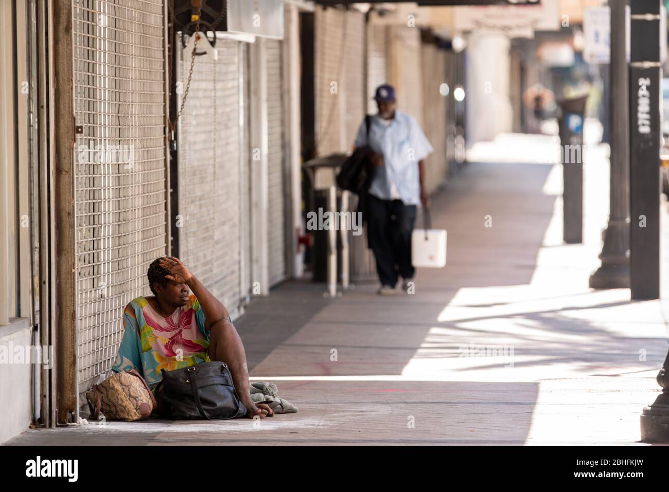 Homeless woman sitting on a sidewalk at Downtown Miami FL Stock Photo ...