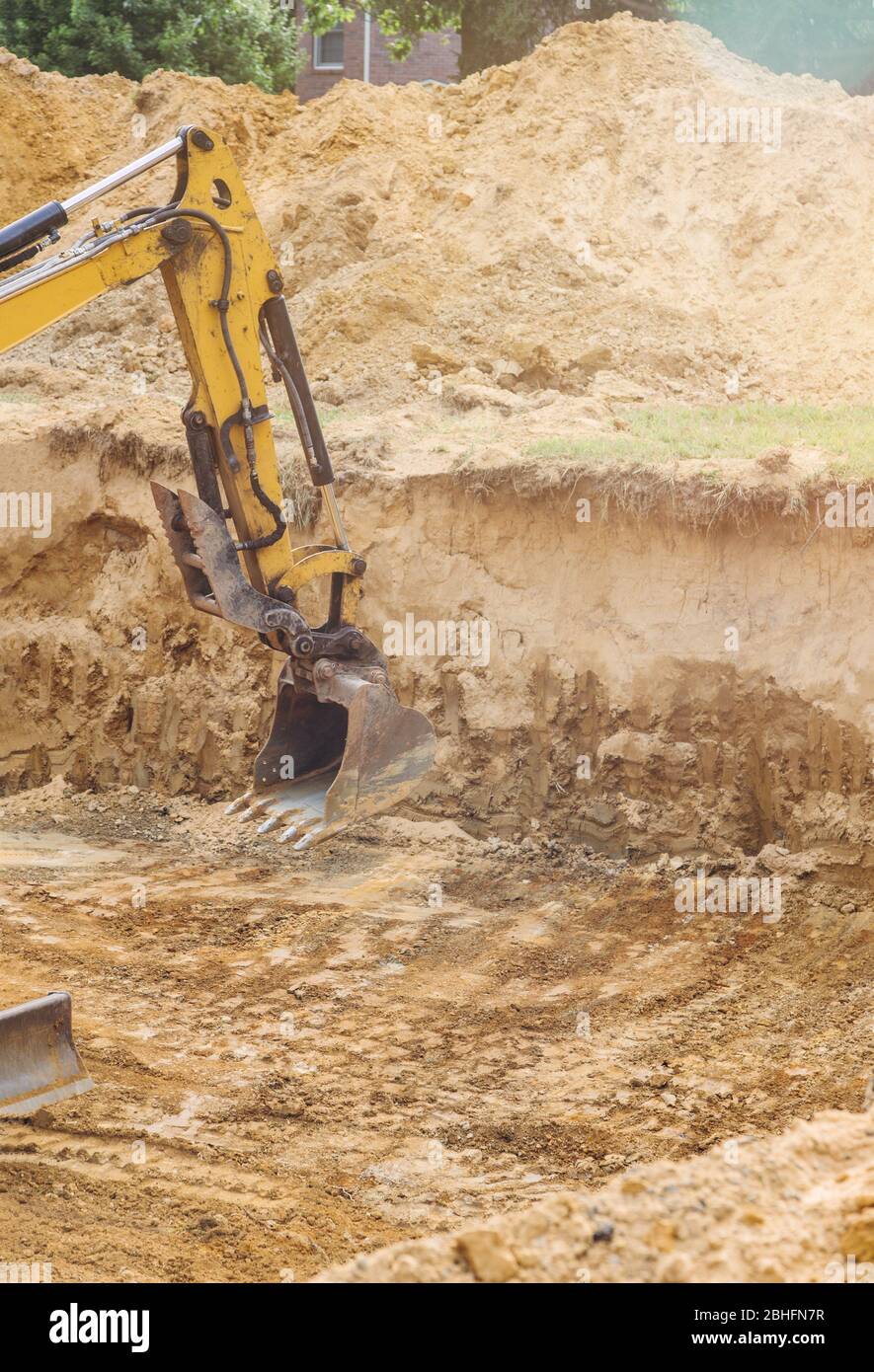 Excavator working bucket moving for foundation at construction site on ...