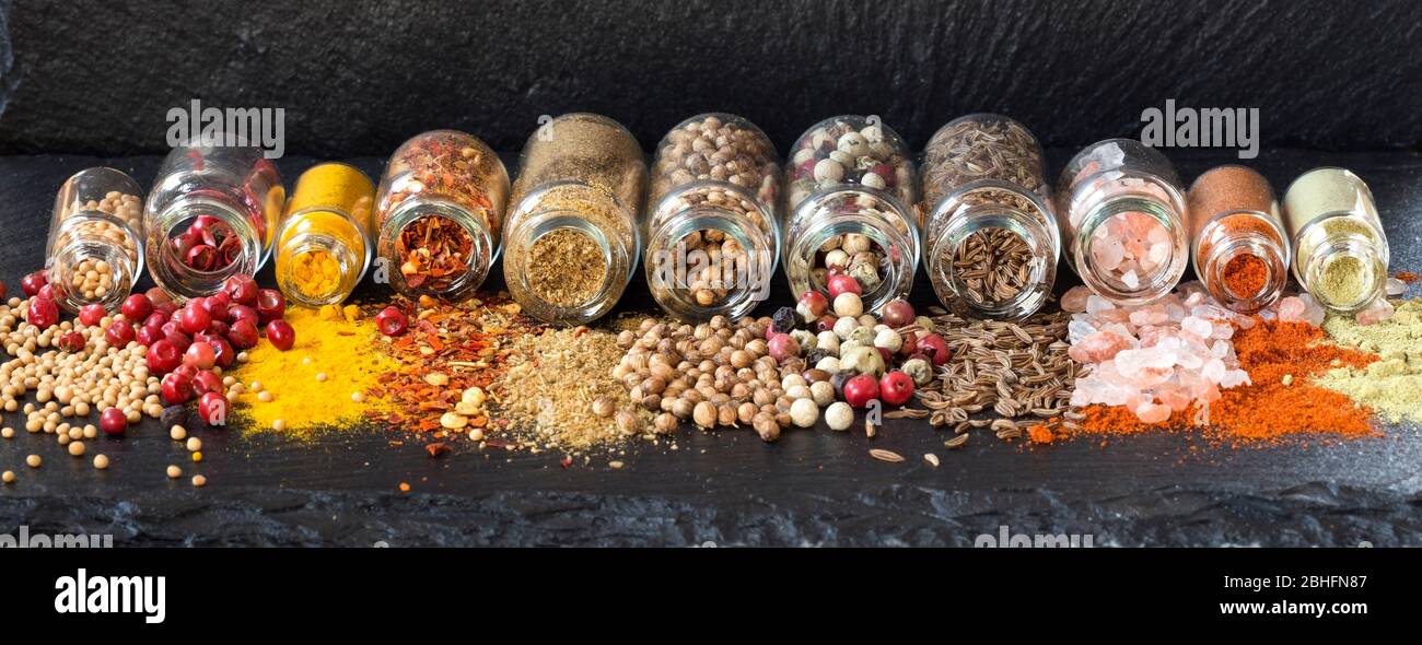 Various spices in small glass bottles Stock Photo - Alamy