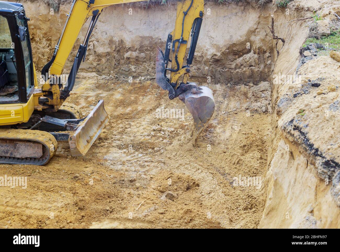 Excavator during earthworks backhoe on work digs ground during ...