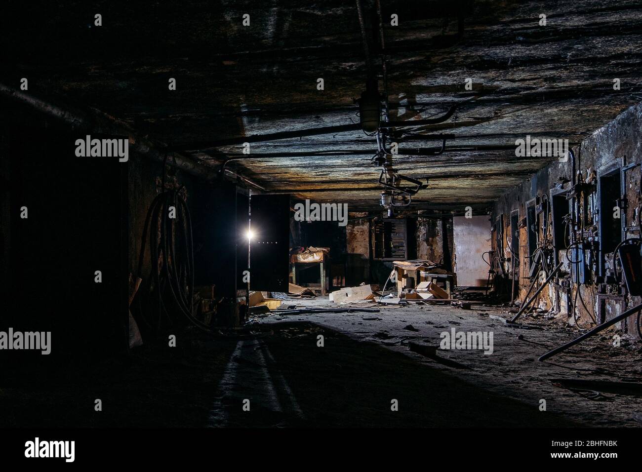 Burnt interior of industrial building basement. Walls in black soot ...