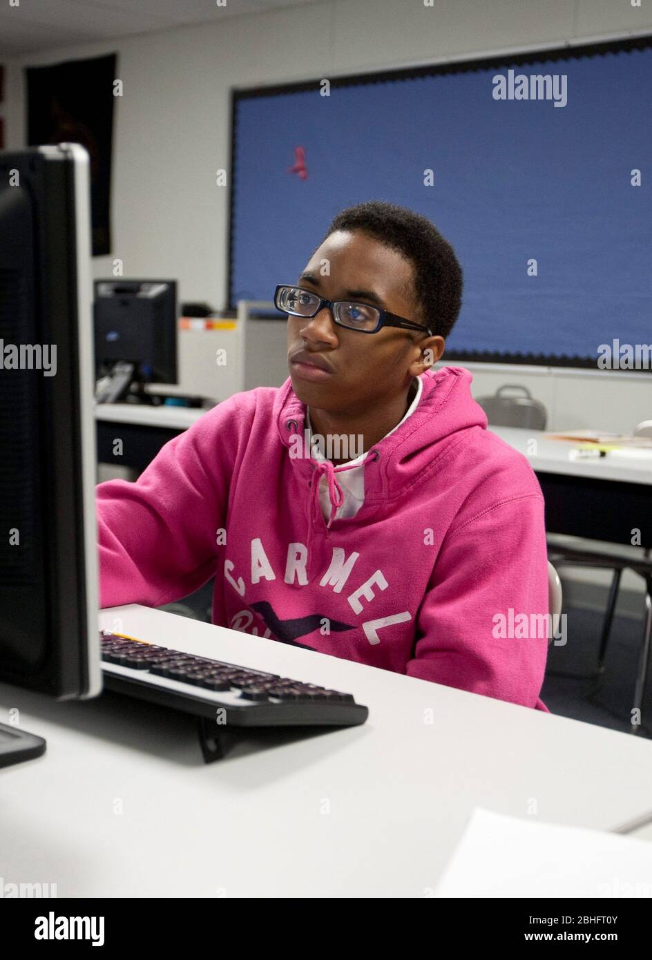 African-American male student in computer lab at a public charter high ...