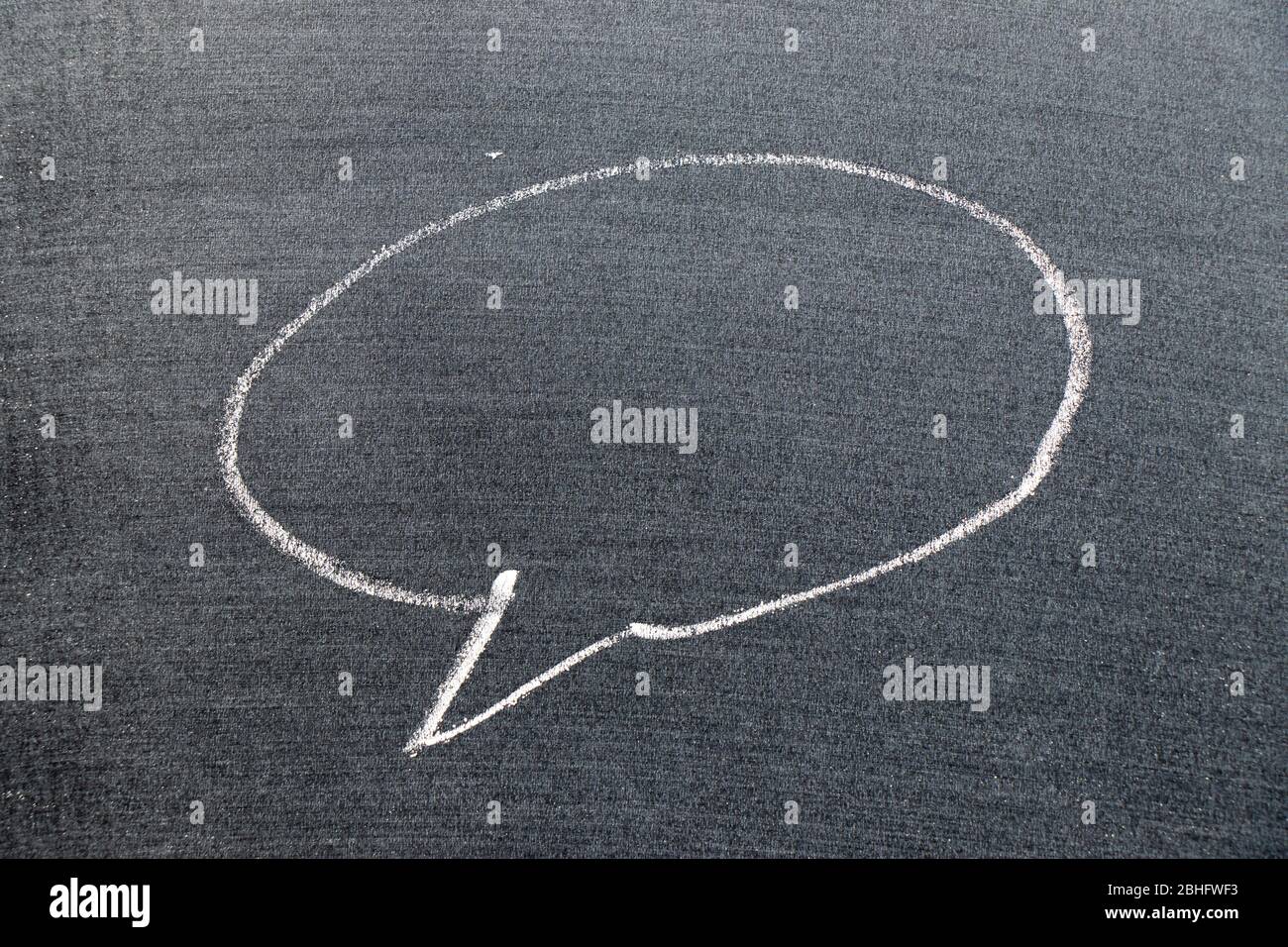 White color chalk hand drawing in round bubble speech shape with blank ...