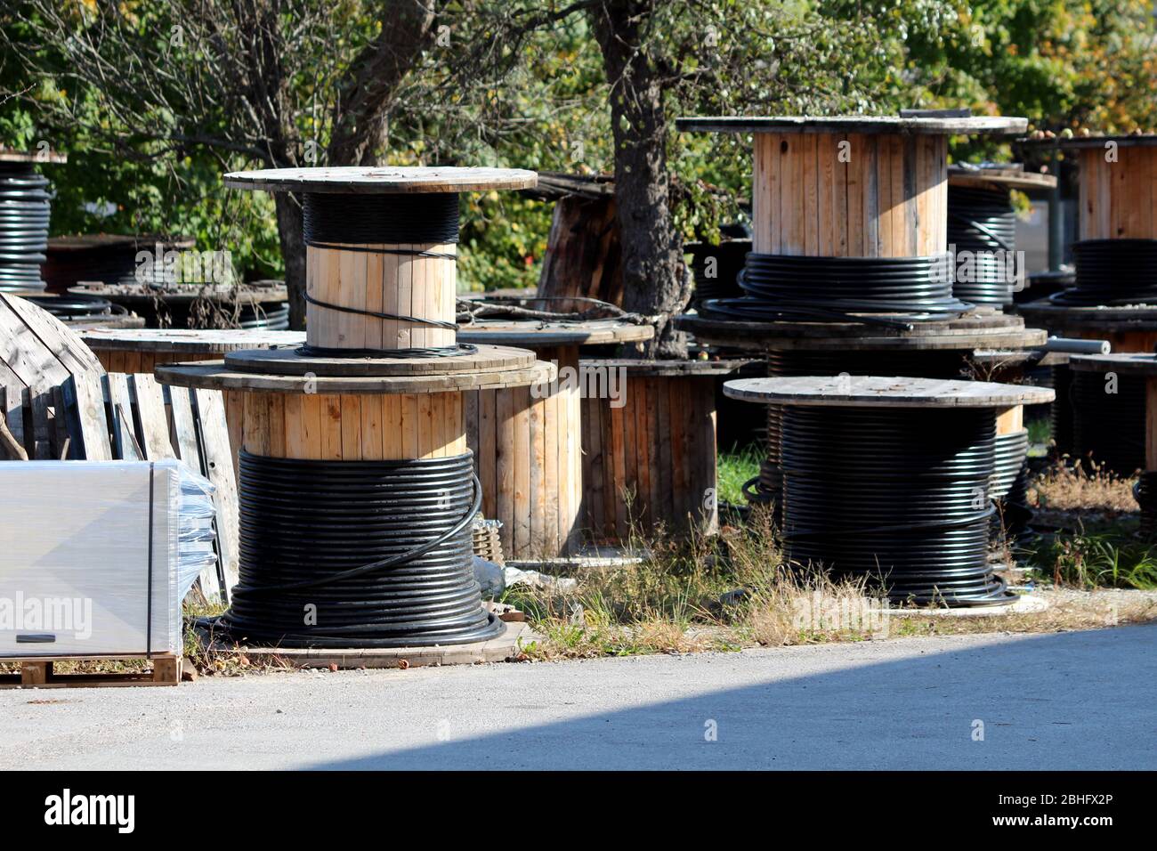 Thick black electrical cable on various sizes industrial wooden cable ...