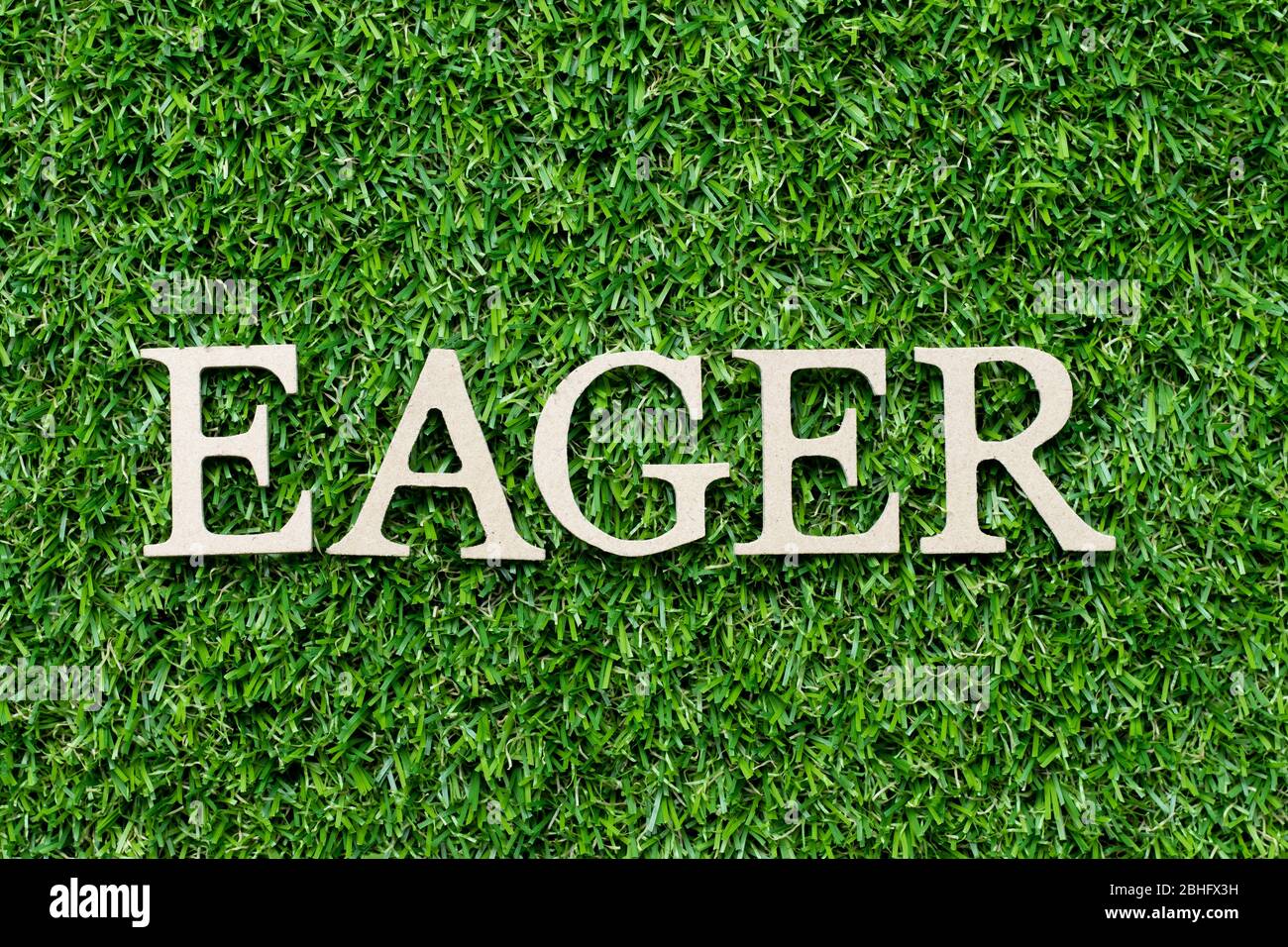 Wood alphabet letter in word eager on green grass background Stock ...