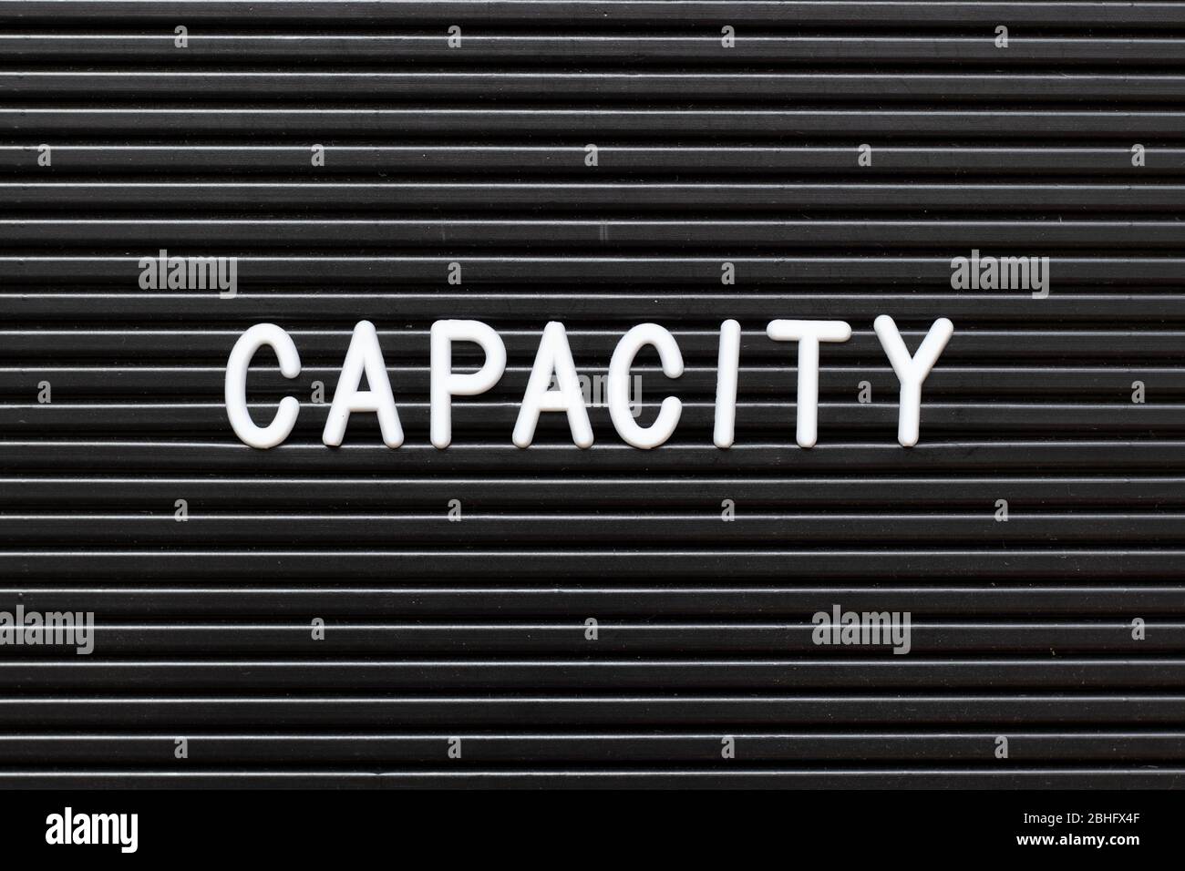 Black felt board with white alphabet in word capacity background Stock ...