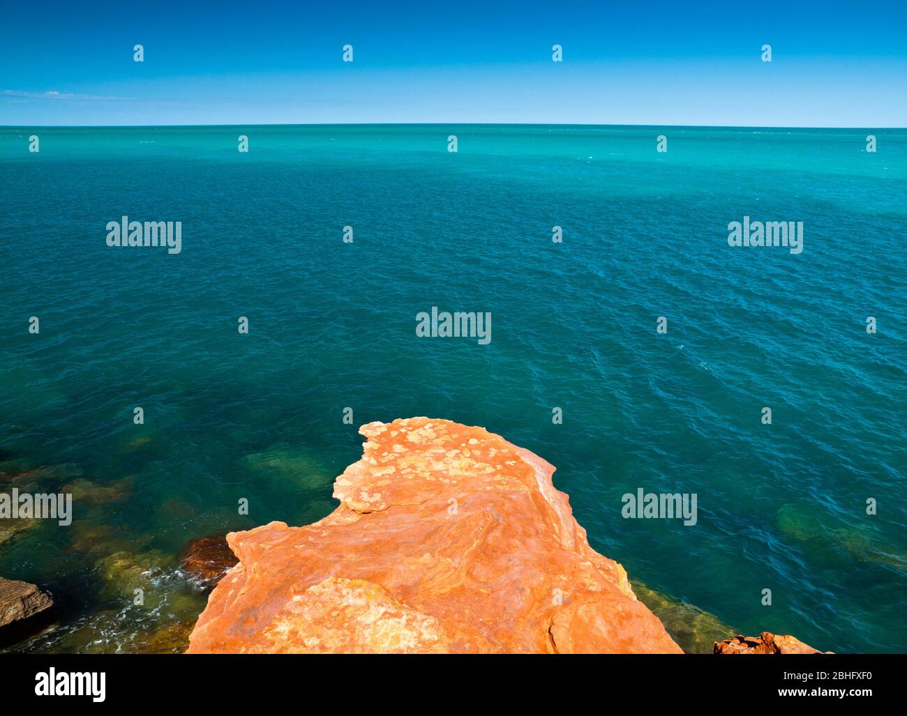 Red sandstone clifftop above a turquoise Indian Ocean near Gantheaume ...