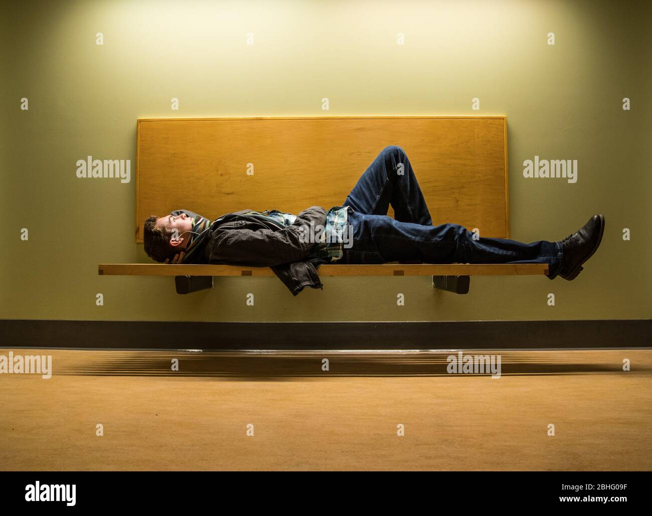 Man laying on bench eyes open thinking Stock Photo - Alamy