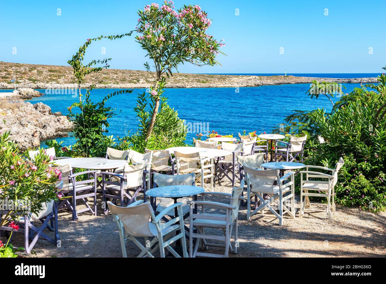 Nice cafeteria with white chairs and tables located at the beach of ...