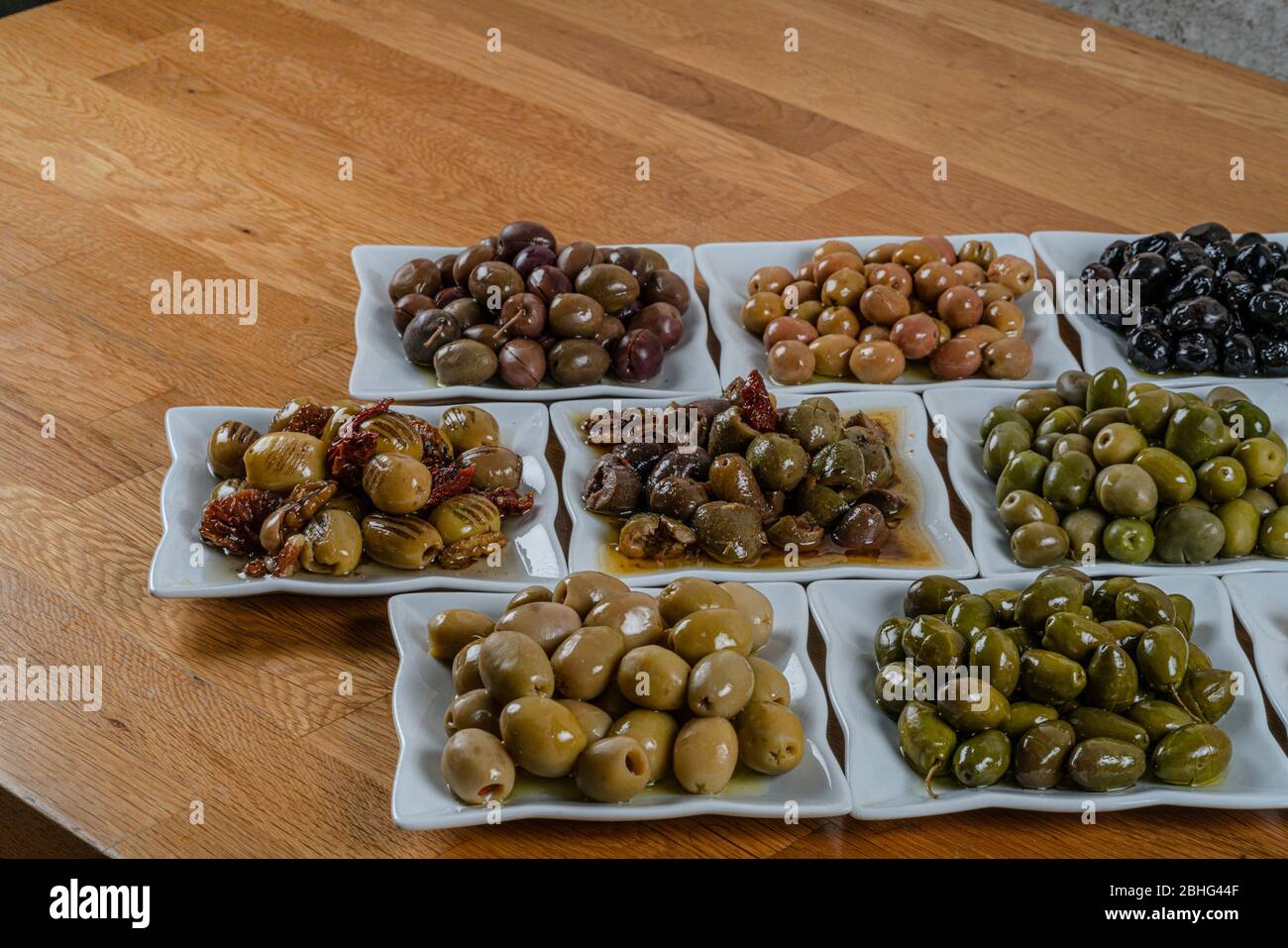 Olives assortment in bowl with oil Stock Photo - Alamy
