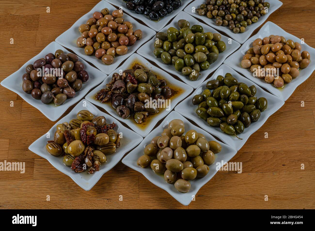Olives assortment in bowl with oil Stock Photo - Alamy