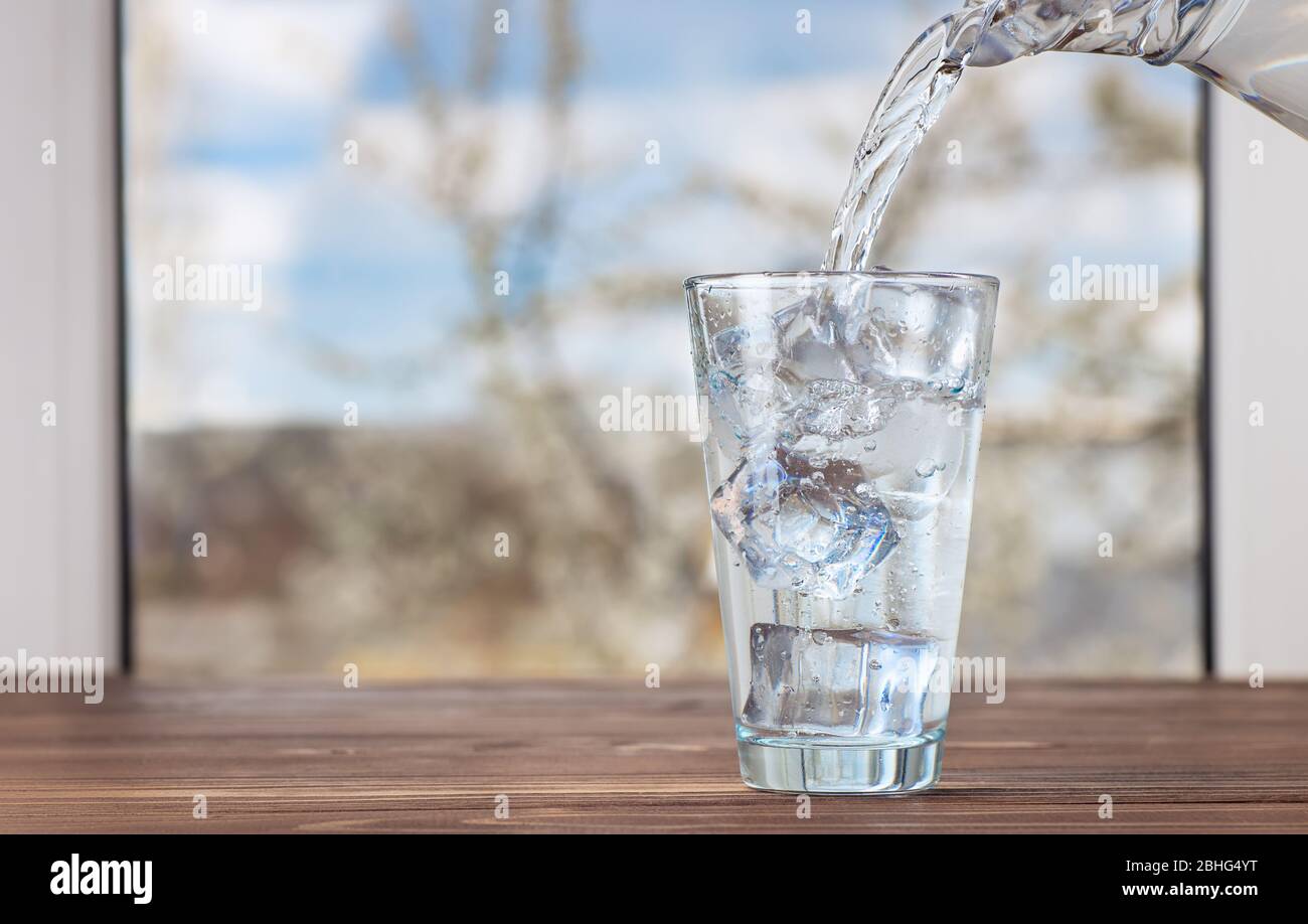 water pouring from jug into glass Stock Photo - Alamy