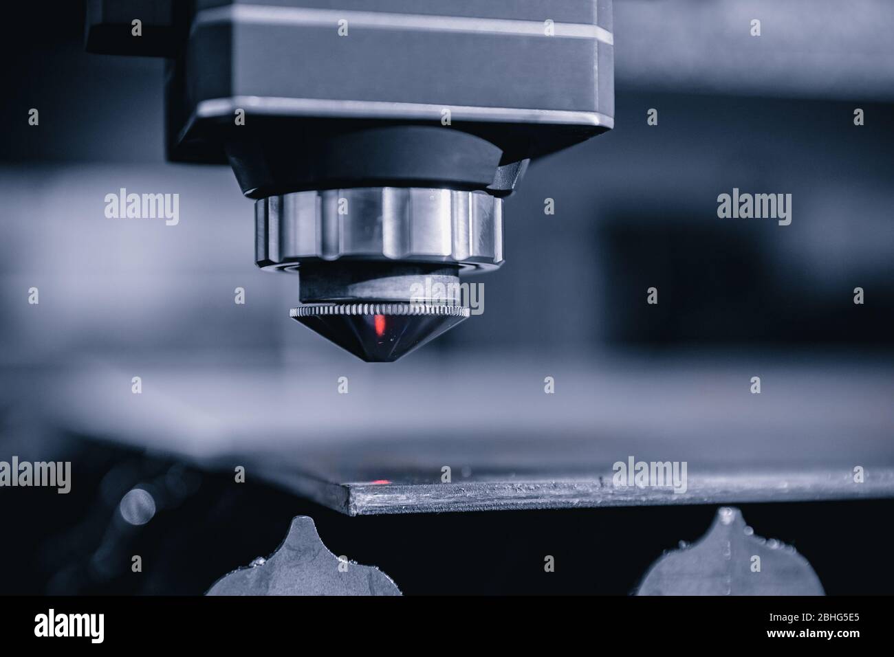 Blue color Laser CNC cut of metal with light spark, technology modern ...