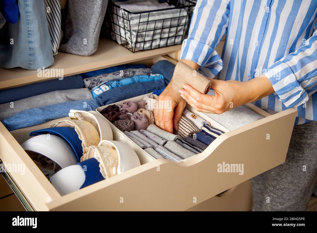 Woman beautifully put things into containers Stock Photo - Alamy