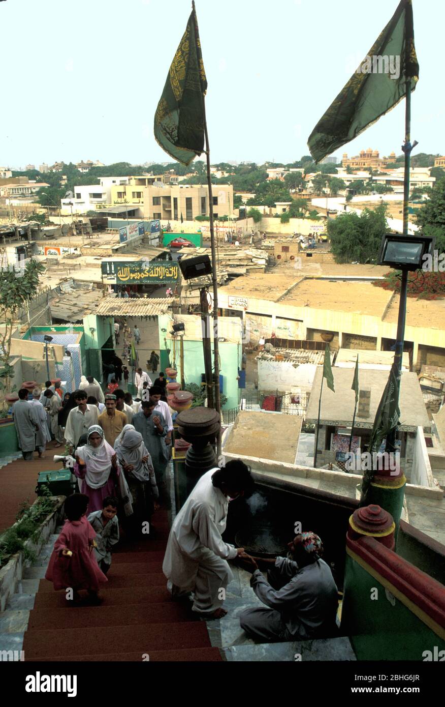 Muslim pilgrims giving a donation outside the Abdullah Shah Ghazi ...