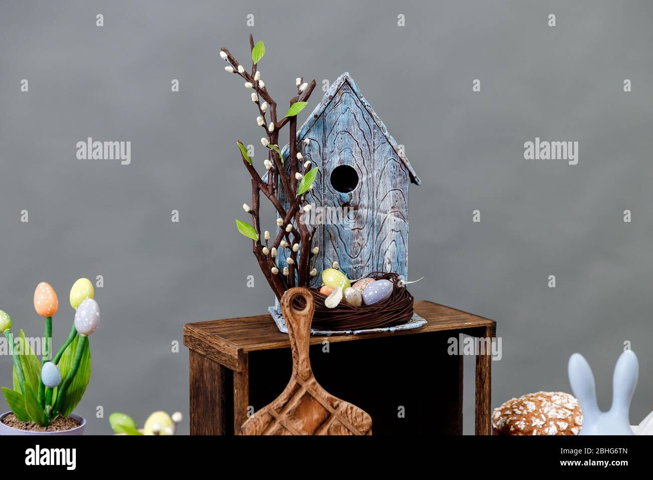 Art pastry chef, chocolate birdhouse with eggs and nest, spring dessert ...